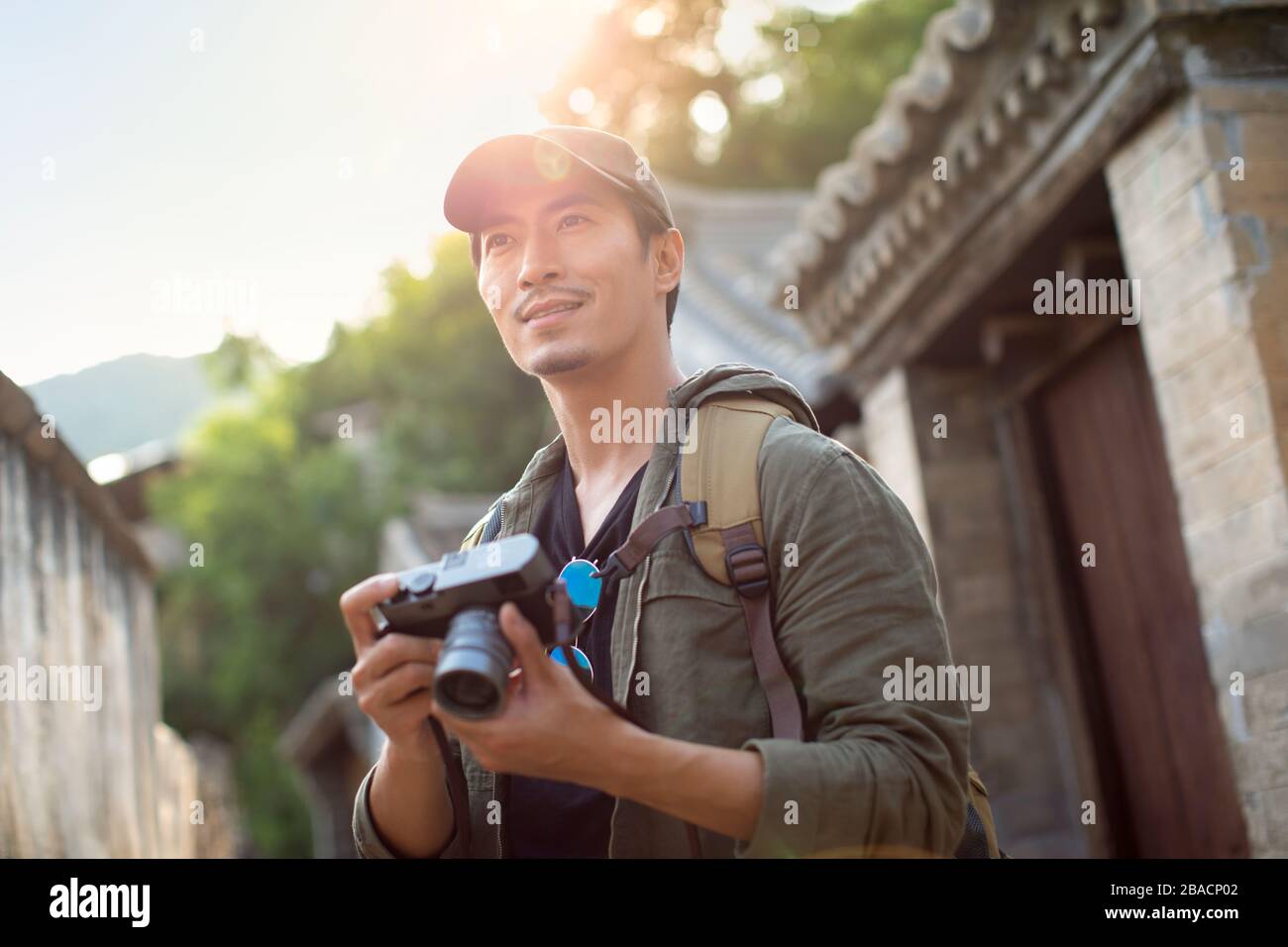 Chinese photographer taking photos in village Stock Photo - Alamy