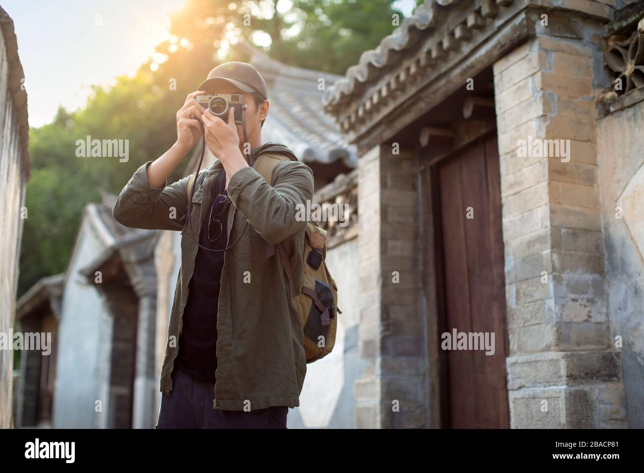 Chinese photographer taking photos in village Stock Photo - Alamy