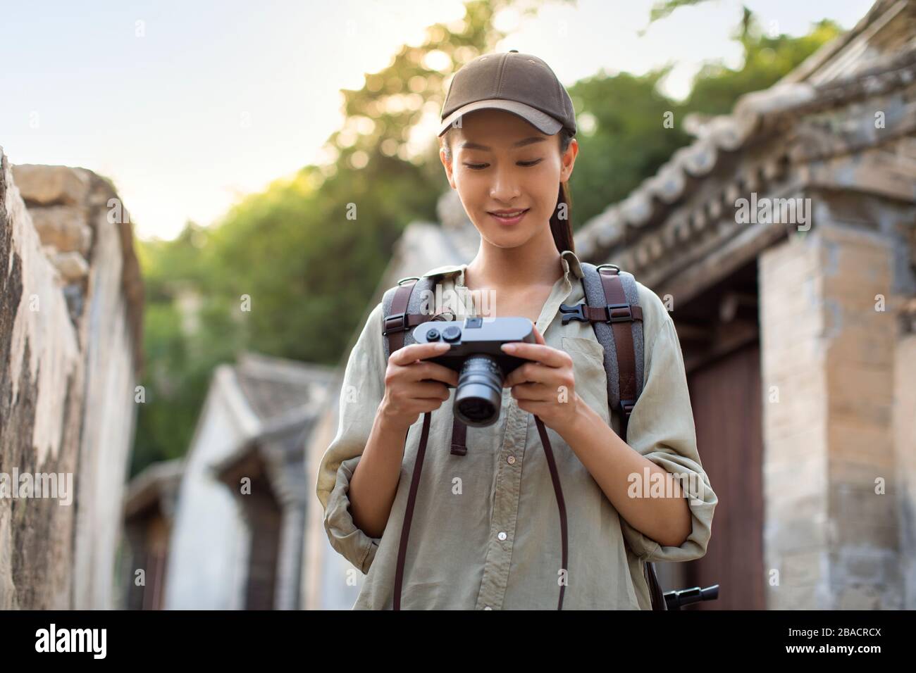 Chinese photographer taking photos in village Stock Photo - Alamy
