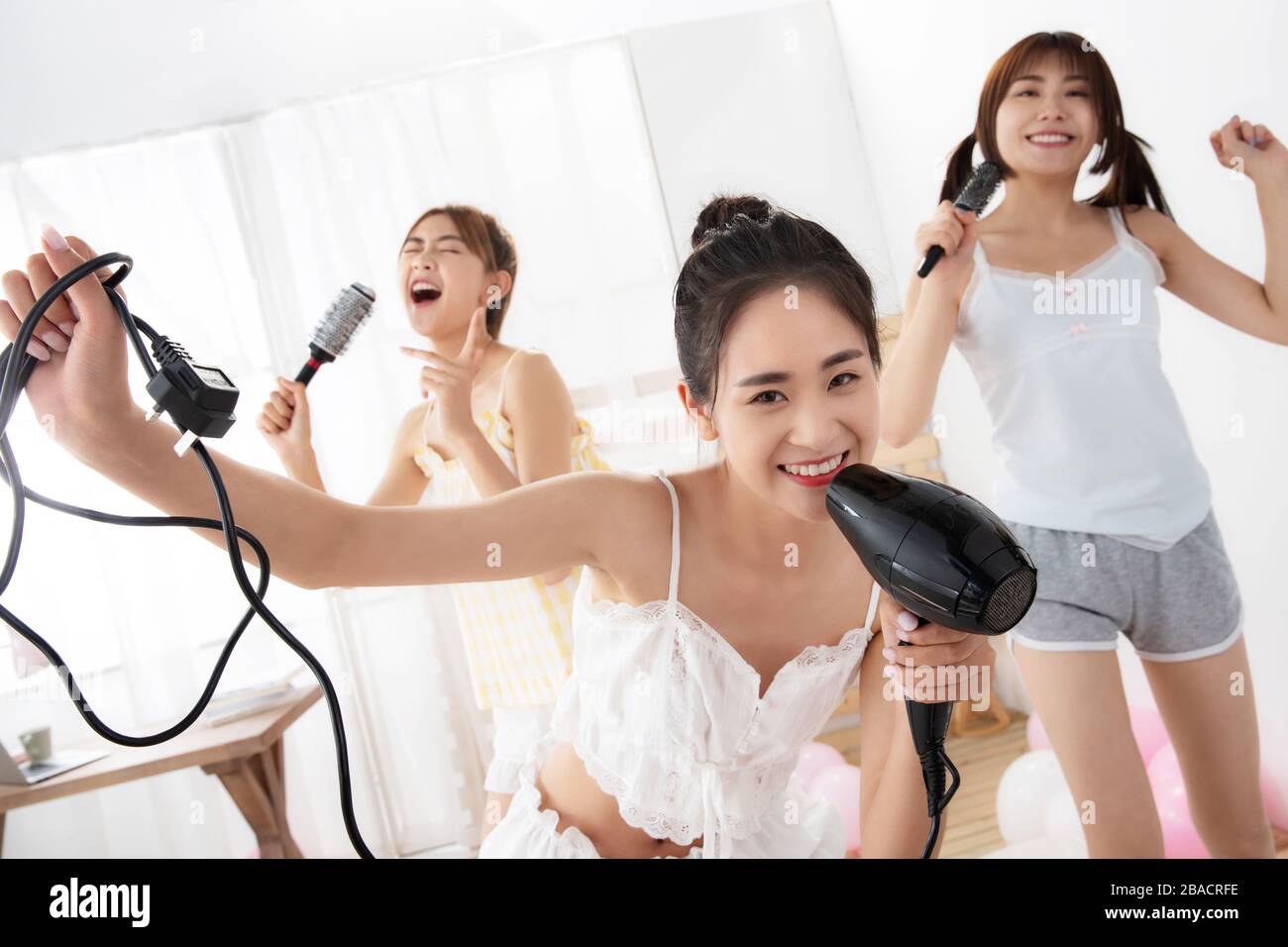 Best friend in the bedroom to play pretend to sing Stock Photo - Alamy