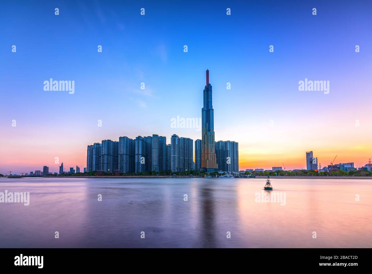 Colorful sunset landscape in a riverside urban area with skyscrapers ...