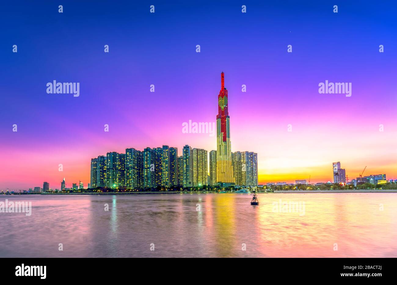 Colorful sunset landscape in a riverside urban area with skyscrapers ...