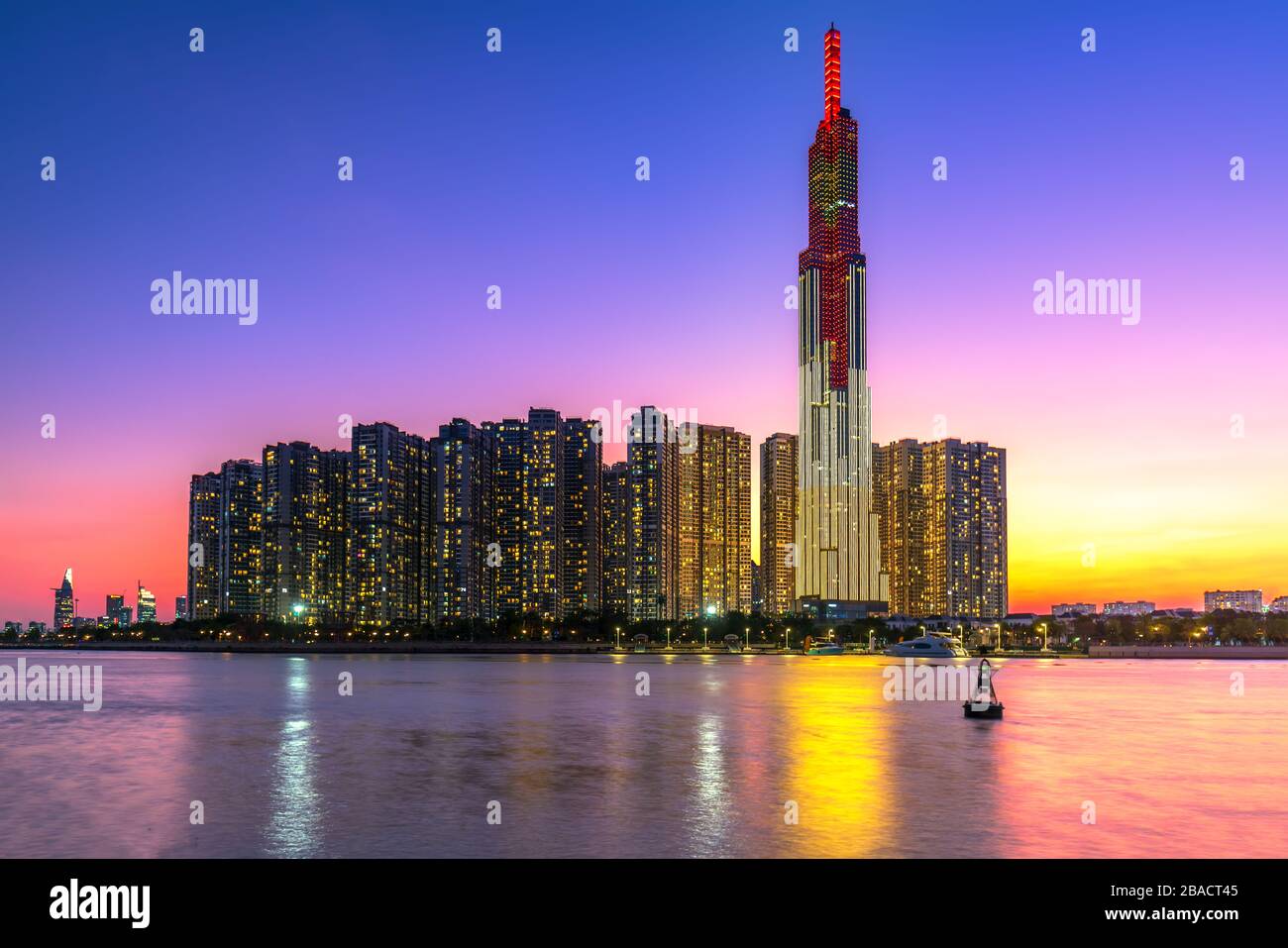 Colorful sunset landscape in a riverside urban area with skyscrapers ...
