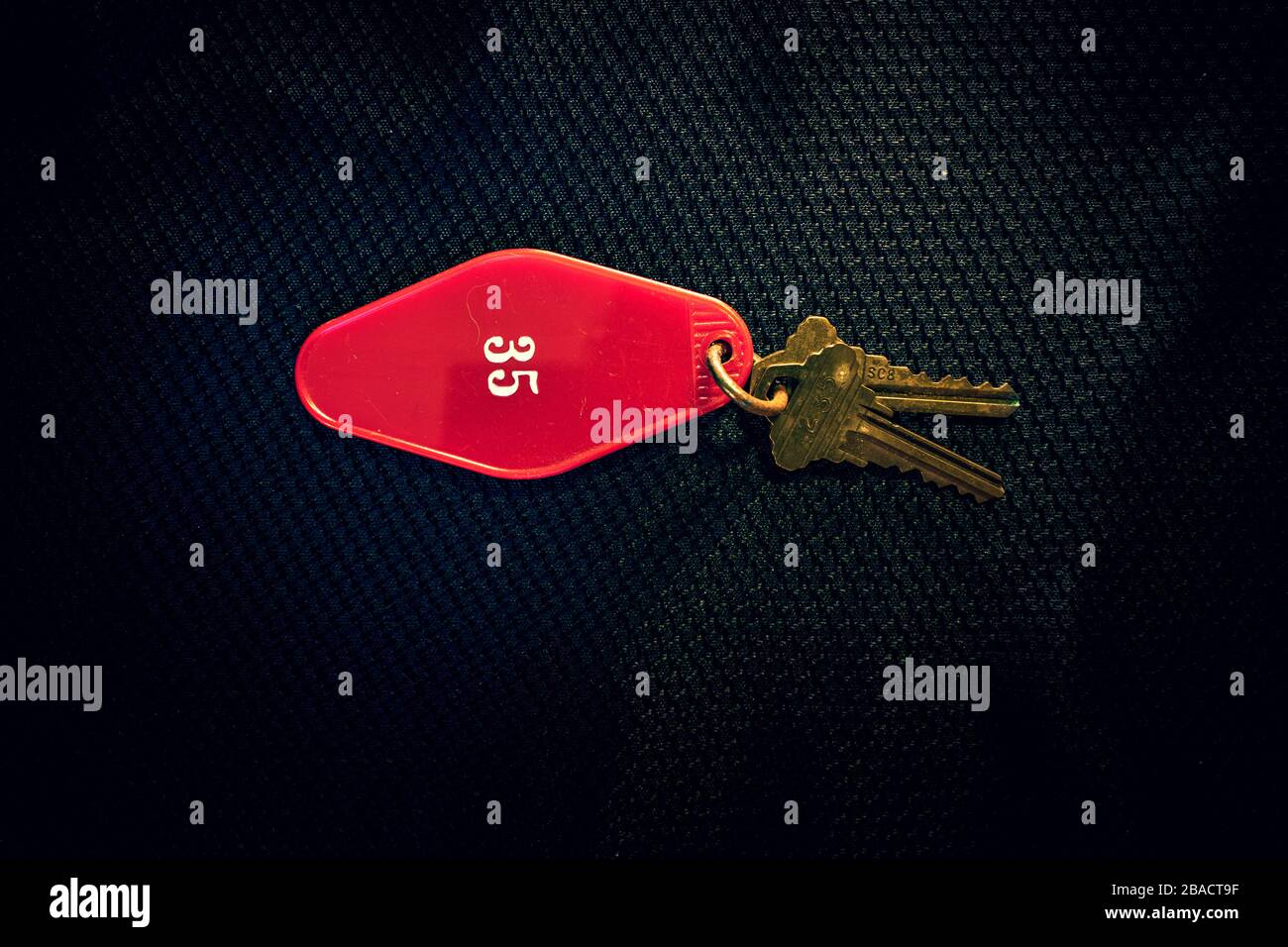 Keys with name sign on black background Stock Photo - Alamy