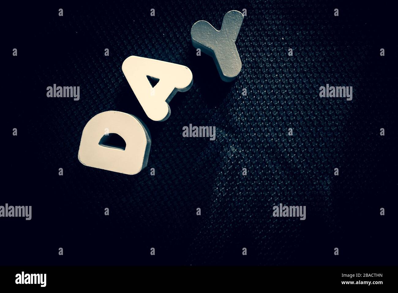 Day spelled on black with block letters Stock Photo - Alamy