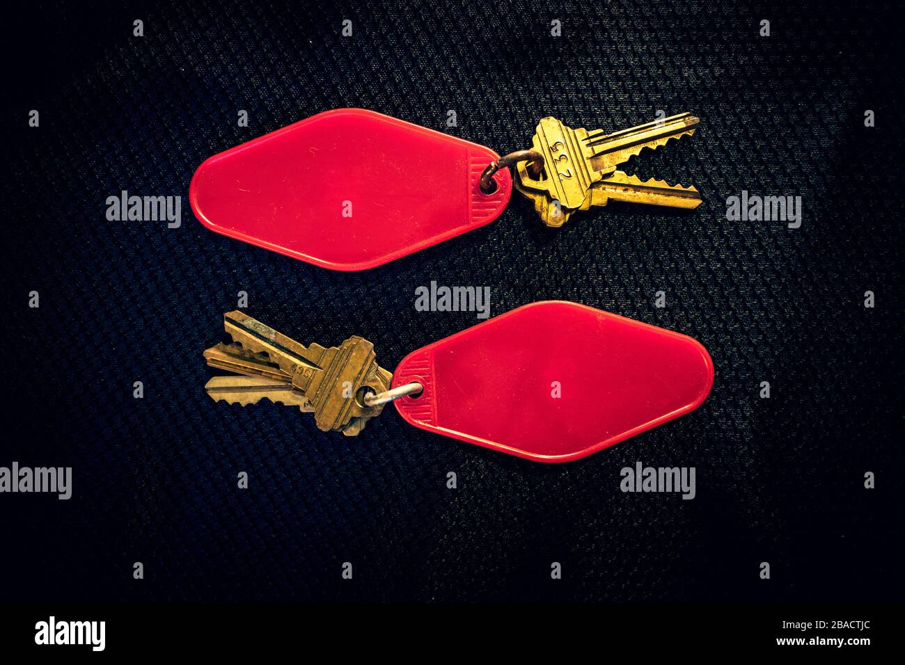 Keys with name sign on black background Stock Photo - Alamy