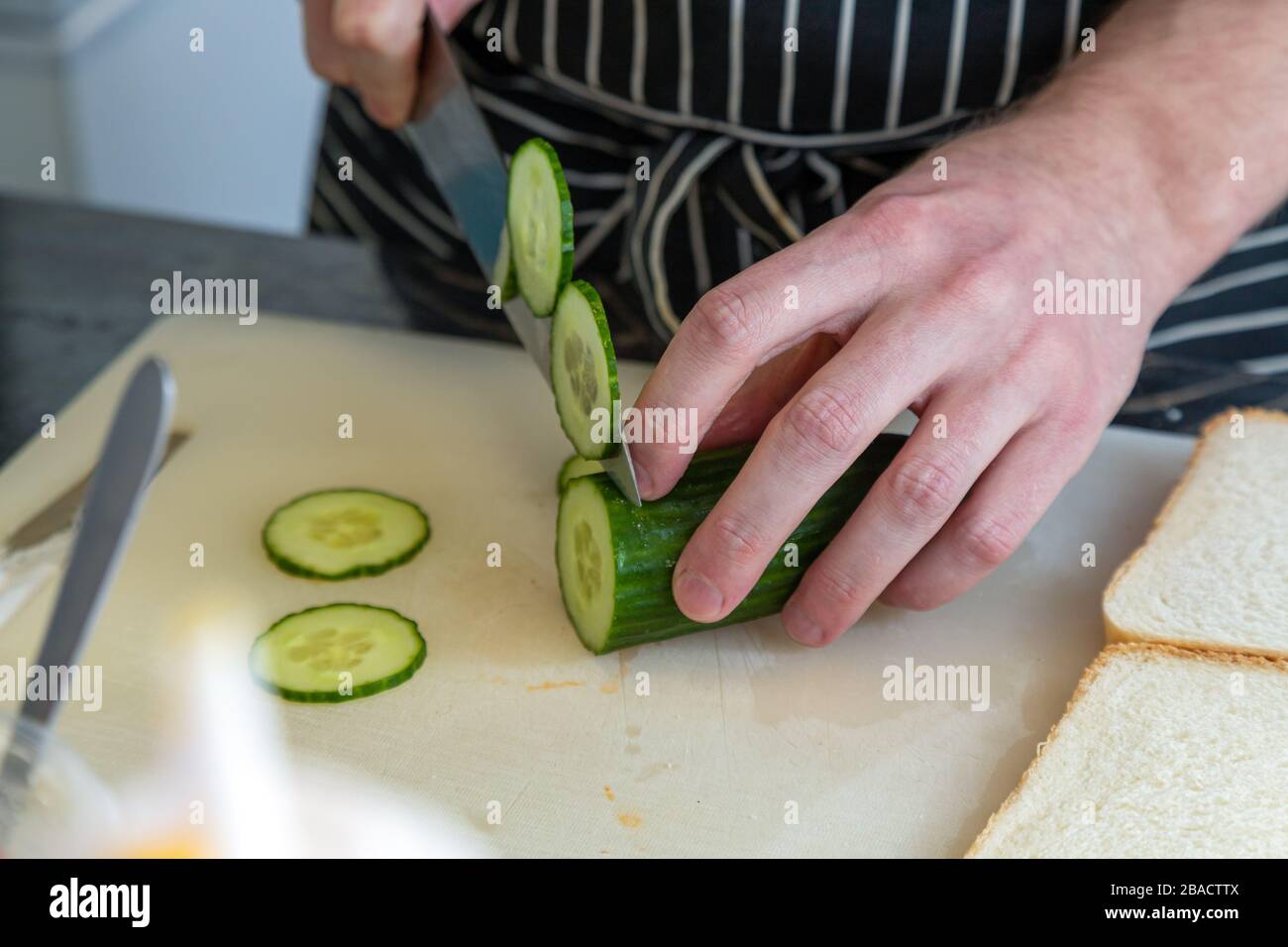 Cook cutting cucumber thin slices hi-res stock photography and images ...