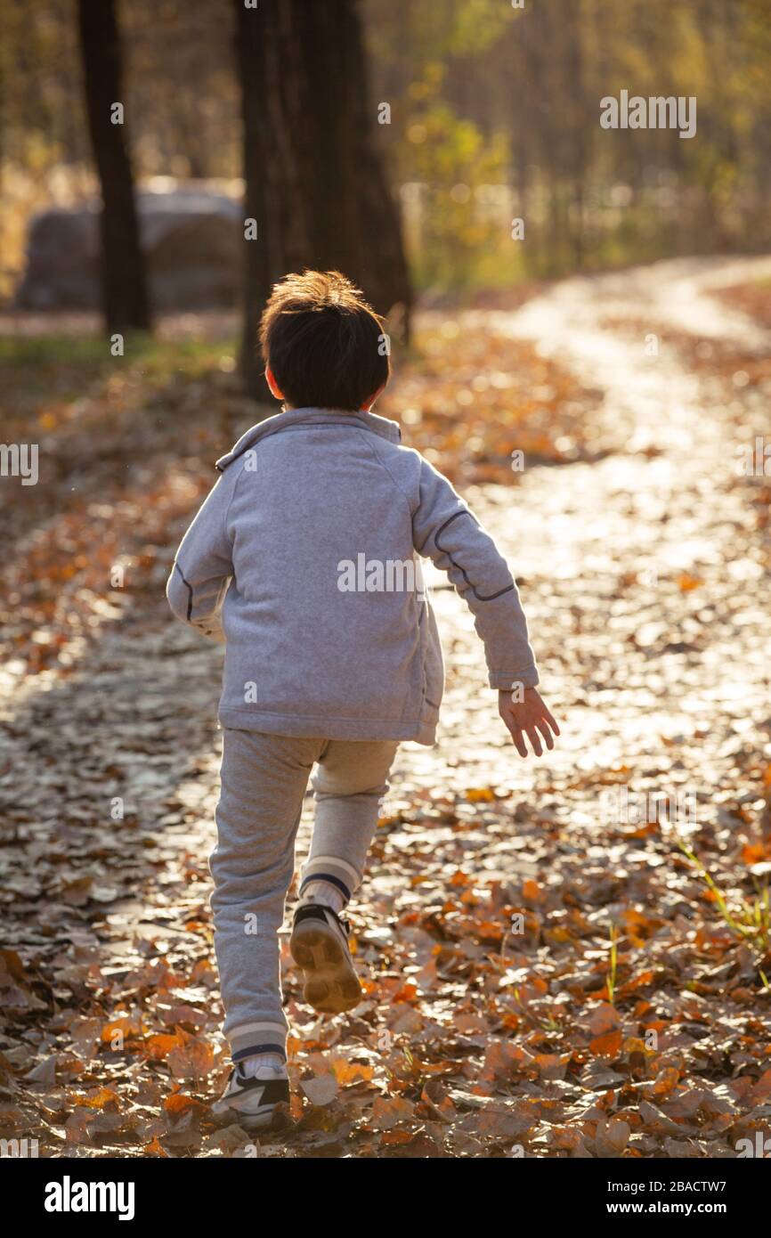 Child running looking back rear view hi-res stock photography and ...