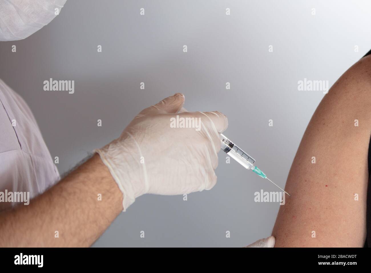 Closeup shot of a doctor injecting a vaccine - the concept of corona ...