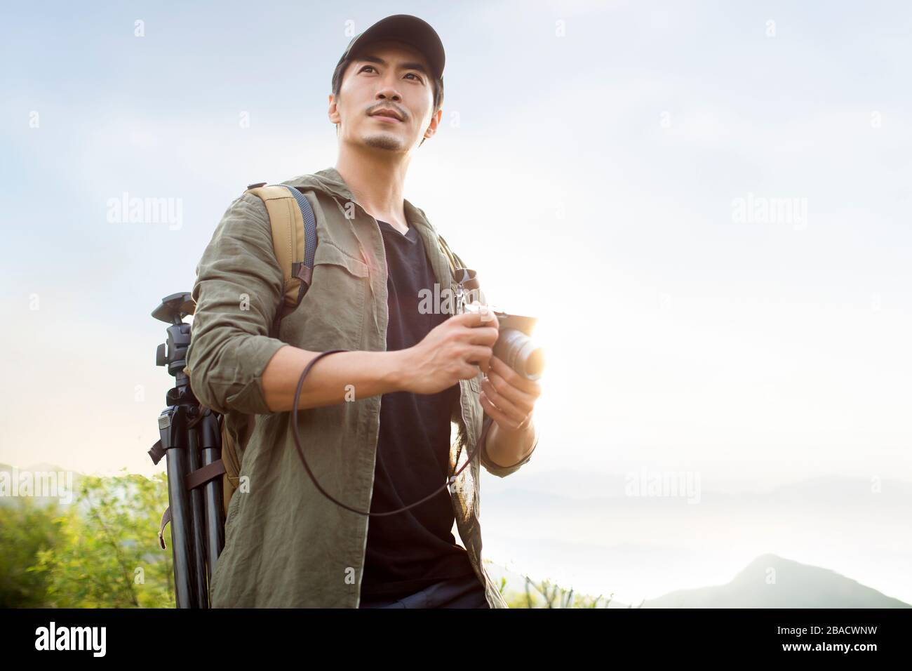 Chinese photographer taking photos outdoors Stock Photo - Alamy
