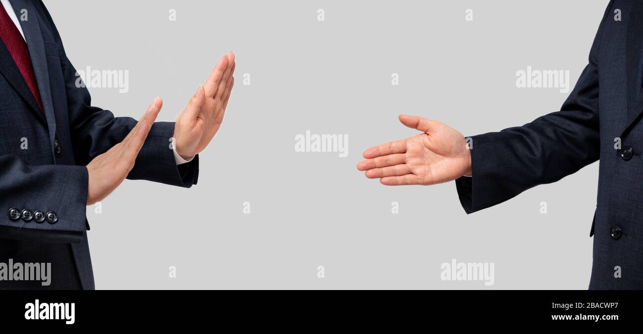 Businessmen facing each other and recommending a handshake and ...