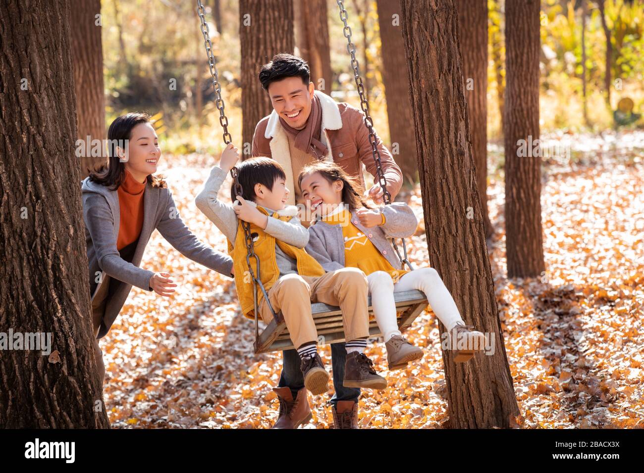Happy families play outdoors Stock Photo - Alamy