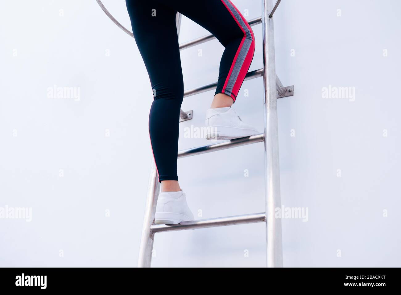 Photo of young girl climbing on ladder step by step Stock Photo - Alamy