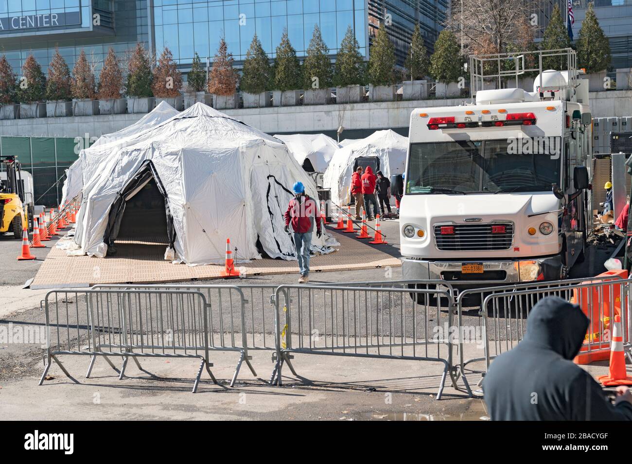 NEW YORK, NY - MARCH 26: Workers build a makeshift morgue outside of ...