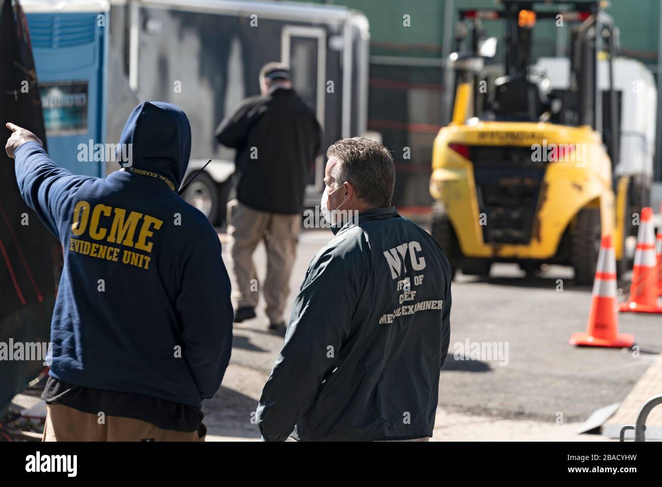 NEW YORK, NY - MARCH 26: Workers build a makeshift morgue outside of ...