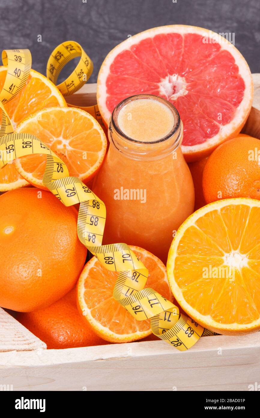 Fresh healthy smoothie from citrus and tape measure. Food containing ...