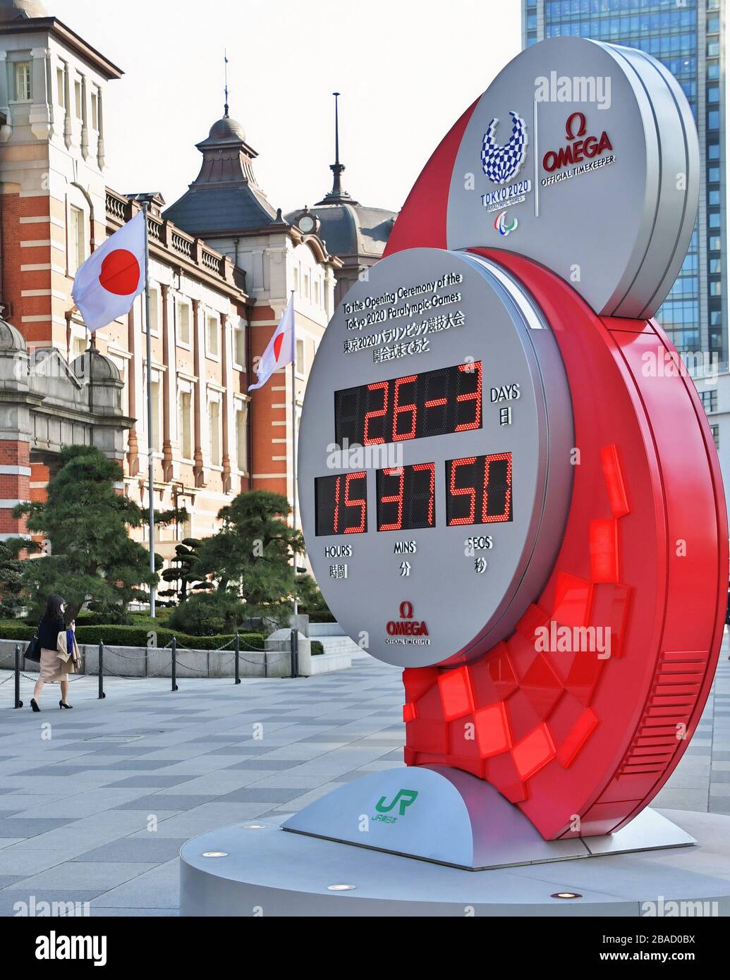 A man takes photo countdown clock for the Tokyo 2020 Olympics displayed ...