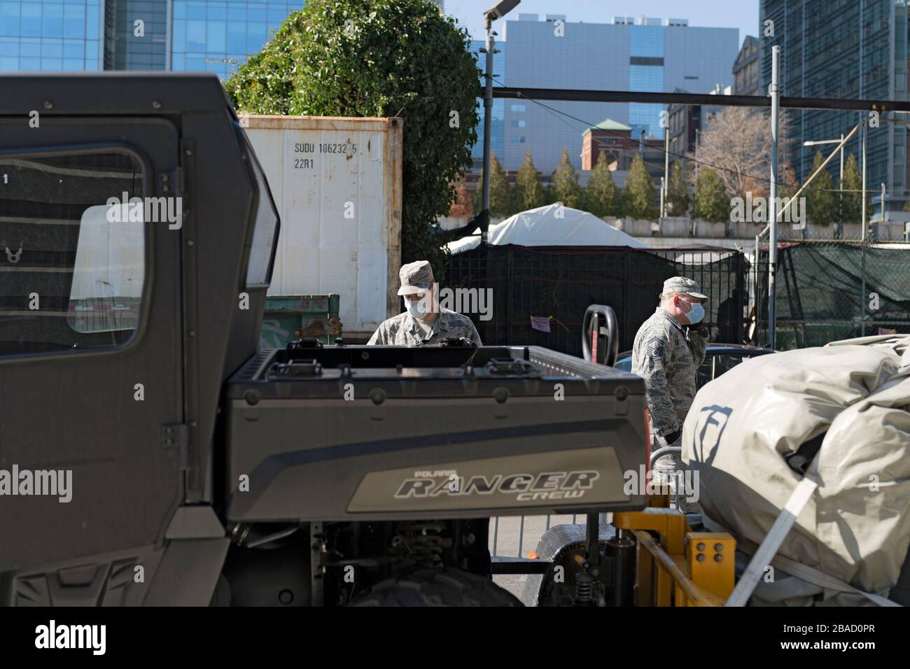 New York, United States. 26th Mar, 2020. Workers build a makeshift ...