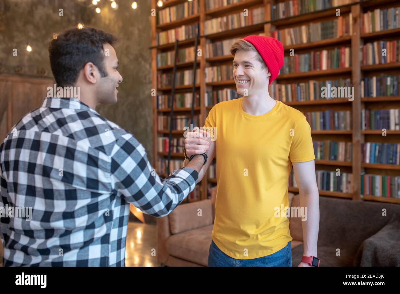 Two young handsome men holding each others hands Stock Photo - Alamy