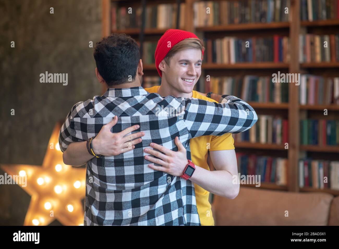 Two young handsome men hugging each other Stock Photo - Alamy