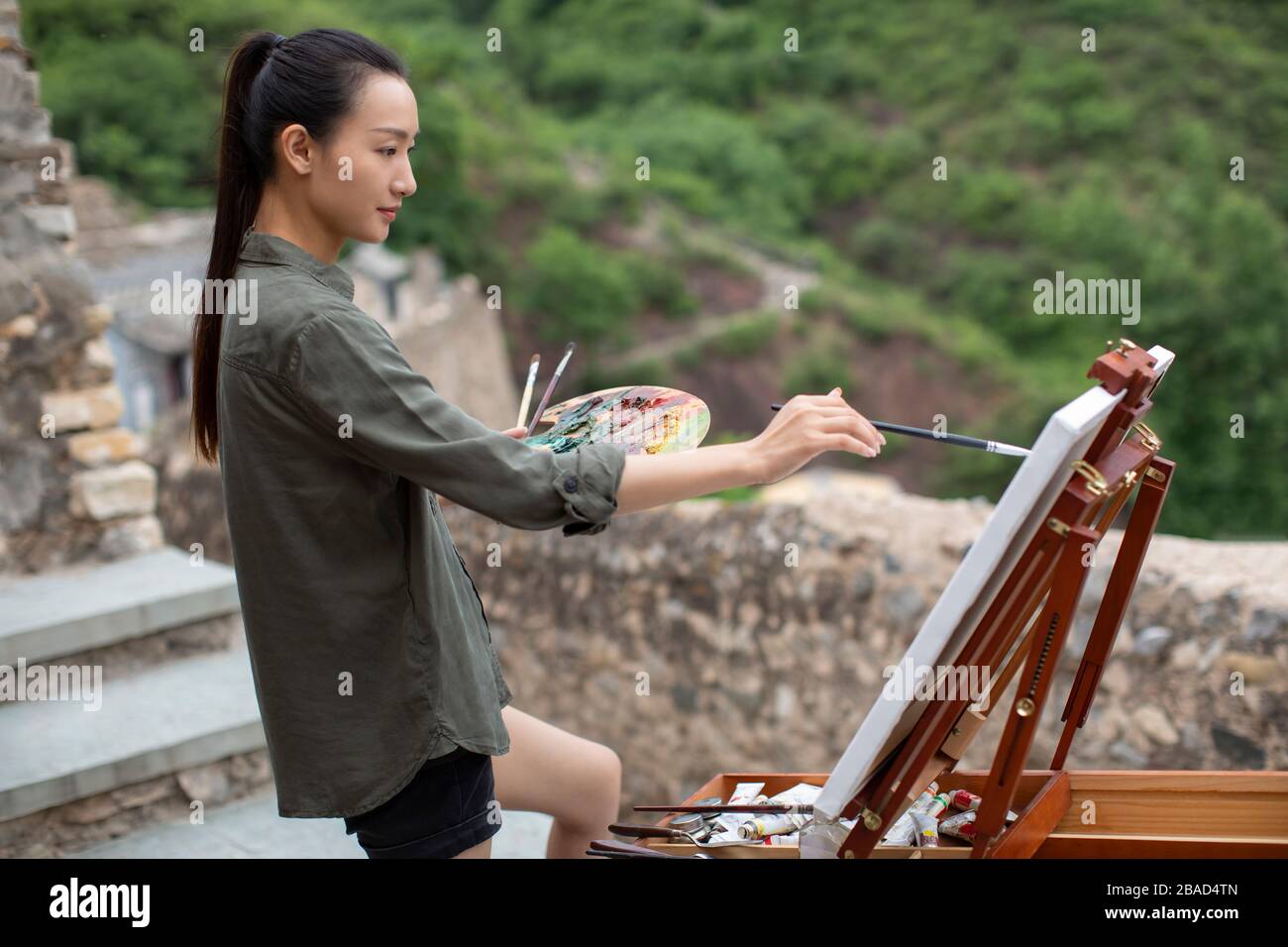 Young Chinese artist painting outdoors Stock Photo - Alamy