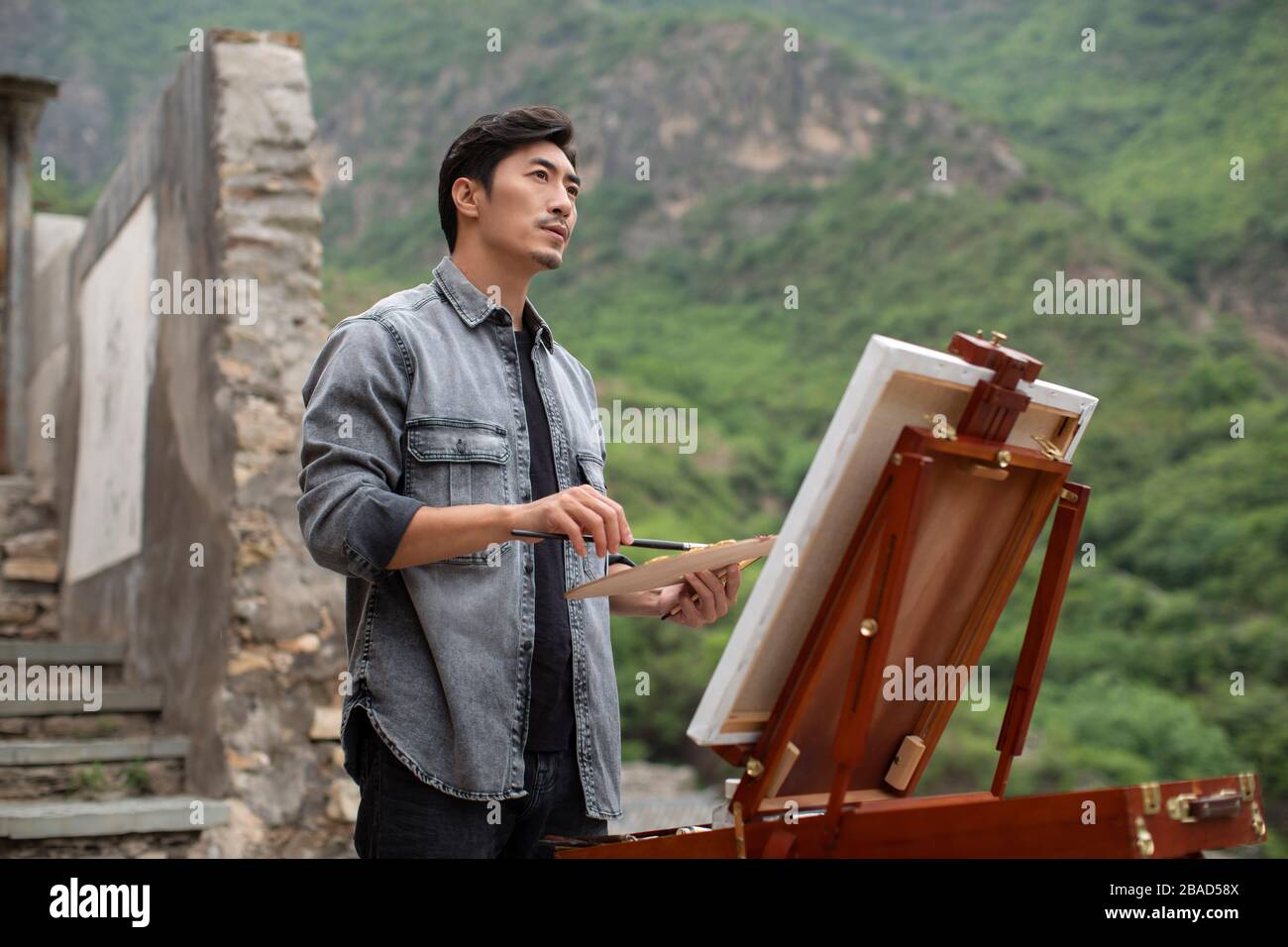 Young Chinese artist painting outdoors Stock Photo - Alamy