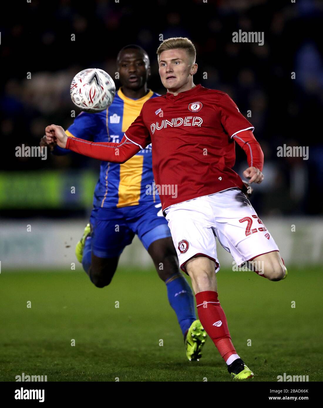 Bristol City's Taylor Moore (front) and Shrewsbury Town's Daniel Udoh ...