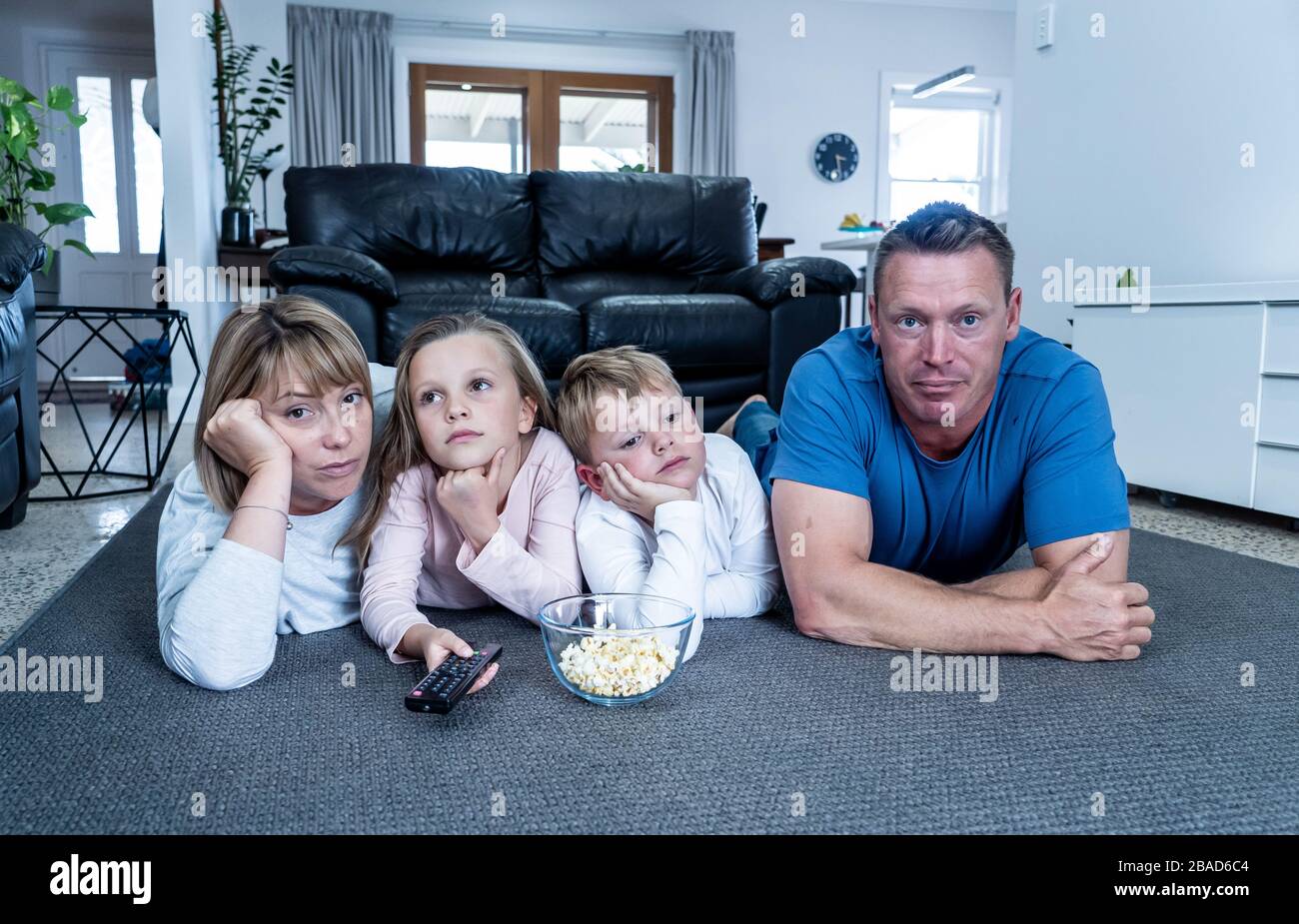 Coronavirus lockdow. Bored family watching tv helpless in isolation at ...