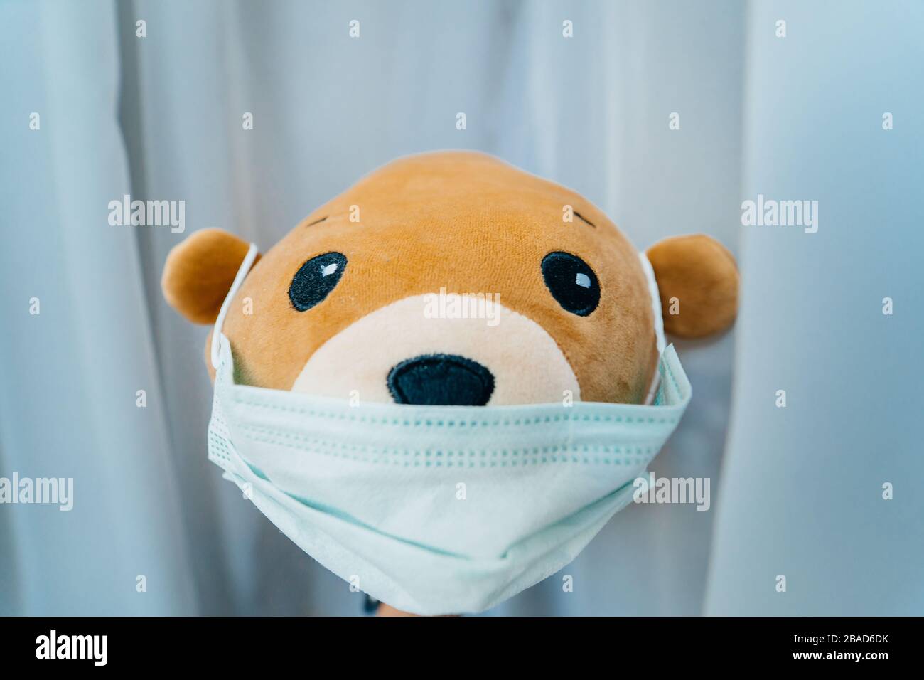 Disposable medical protective face mask on brown teddy bear Stock Photo ...