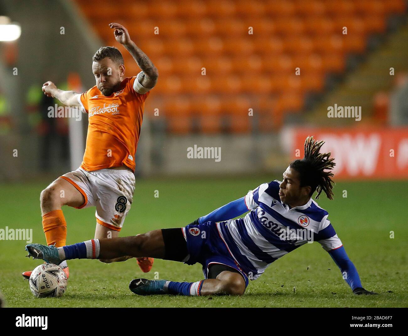 Blackpool's Jay Spearing battles for the ball with Reading's Danny ...