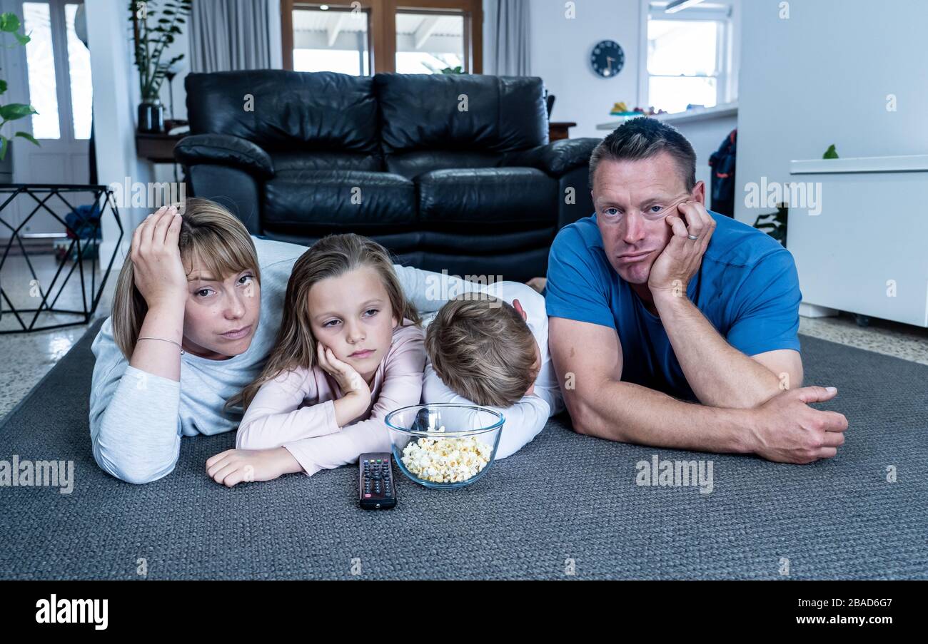 Coronavirus lockdow. Bored family watching tv helpless in isolation at ...