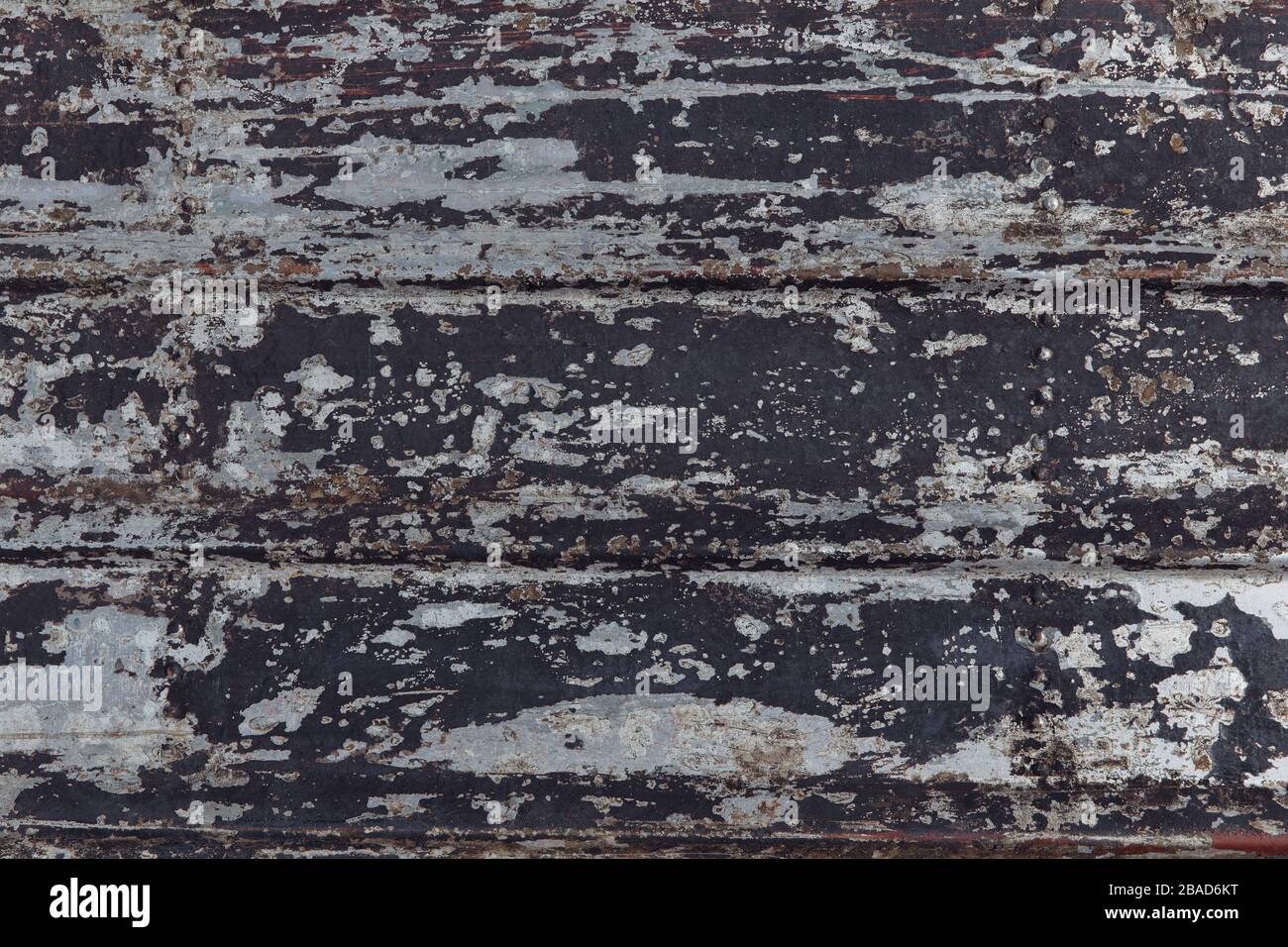 The bottom of an old metal boat. Texture. Sheets of metal are visible ...