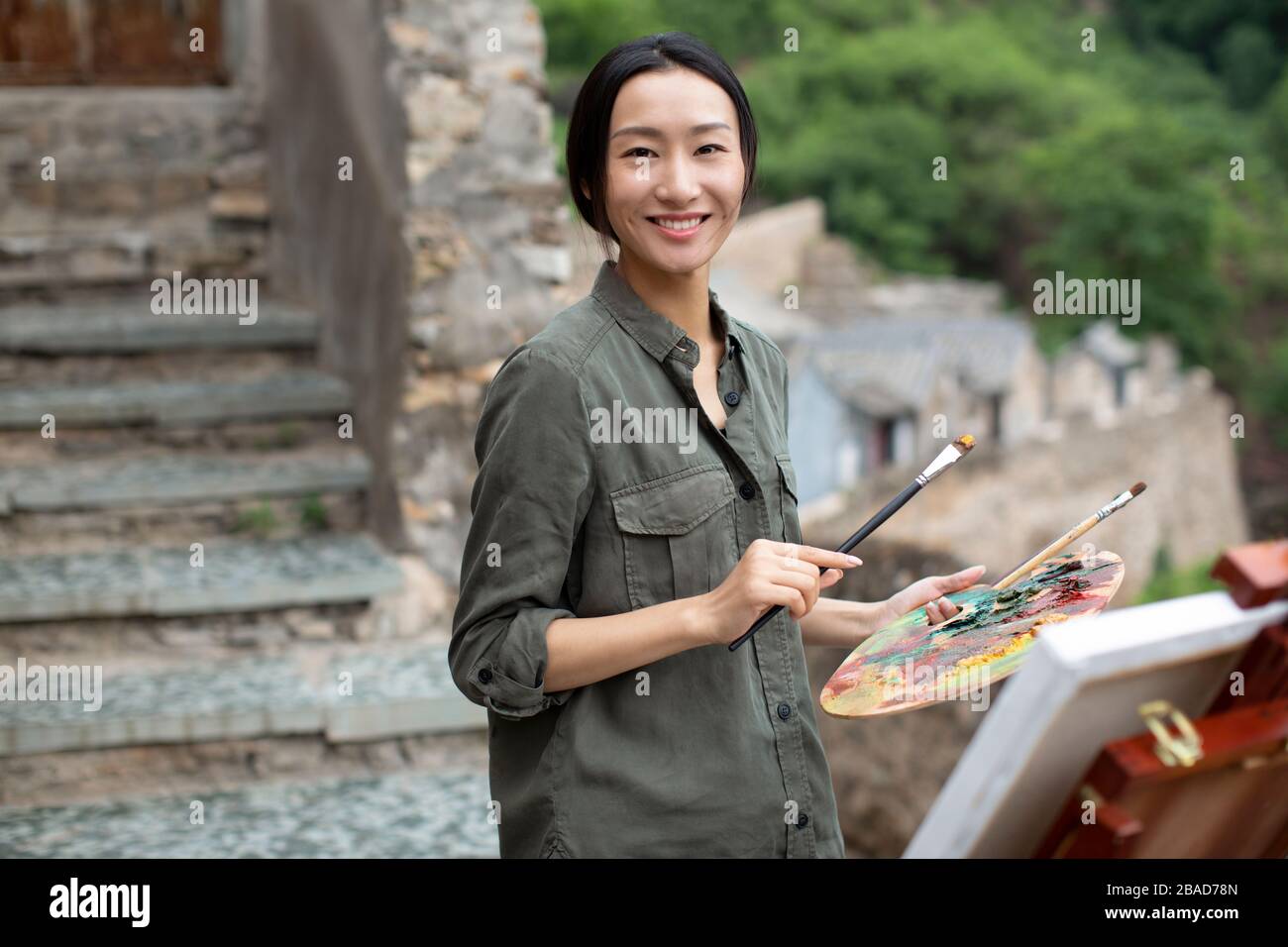 Standing looking arts culture and entertainment painting hi-res stock ...