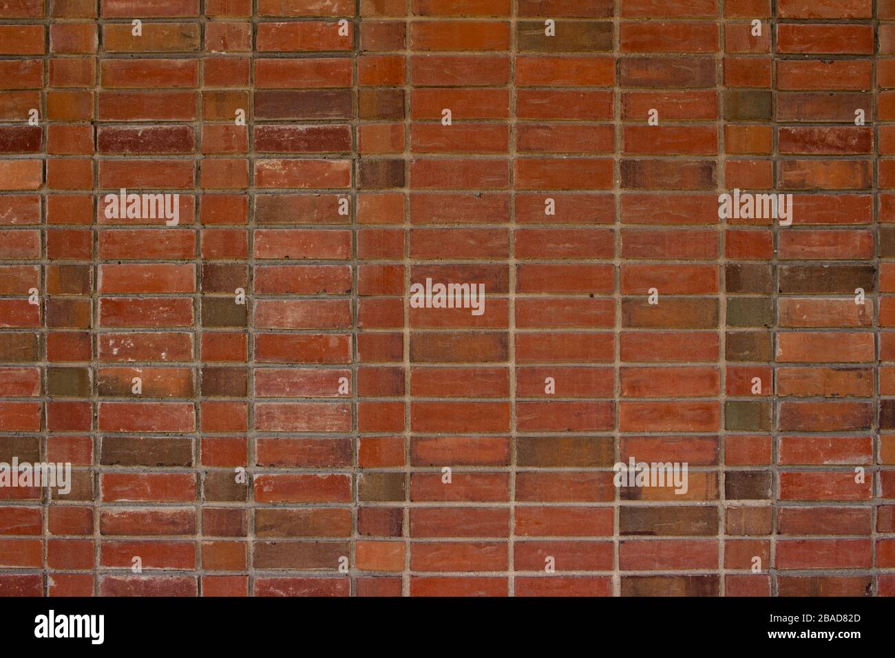 Older weathered red and brown brick wall texture background with a ...