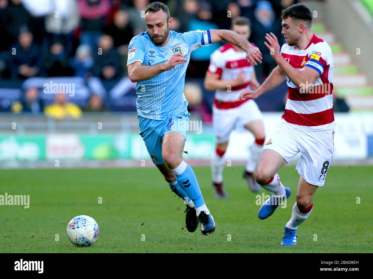 Coventry City's Liam Kelly and Doncaster Rovers Ben Whiteman battle for ...