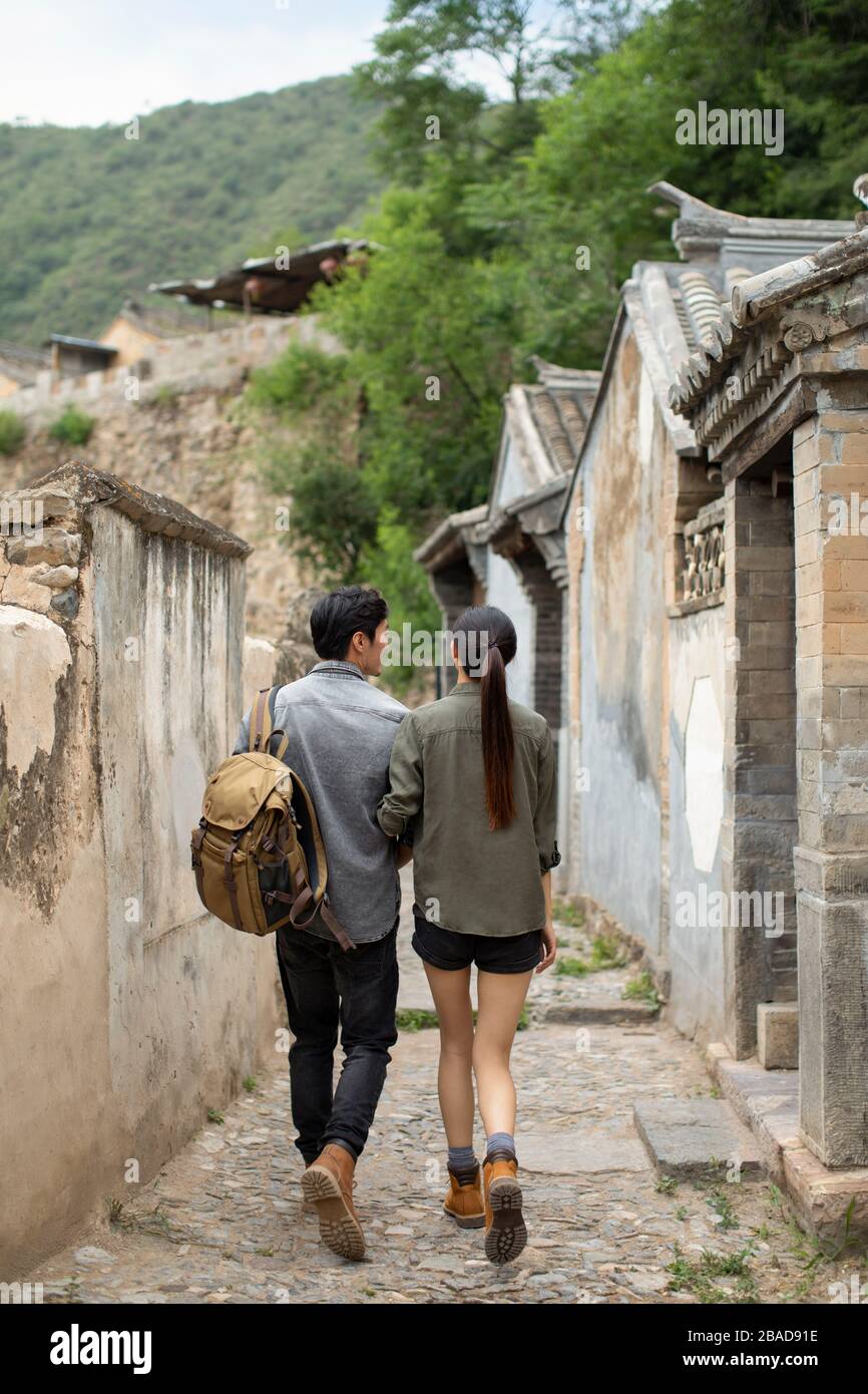 Back view couple walking arm hi-res stock photography and images - Alamy