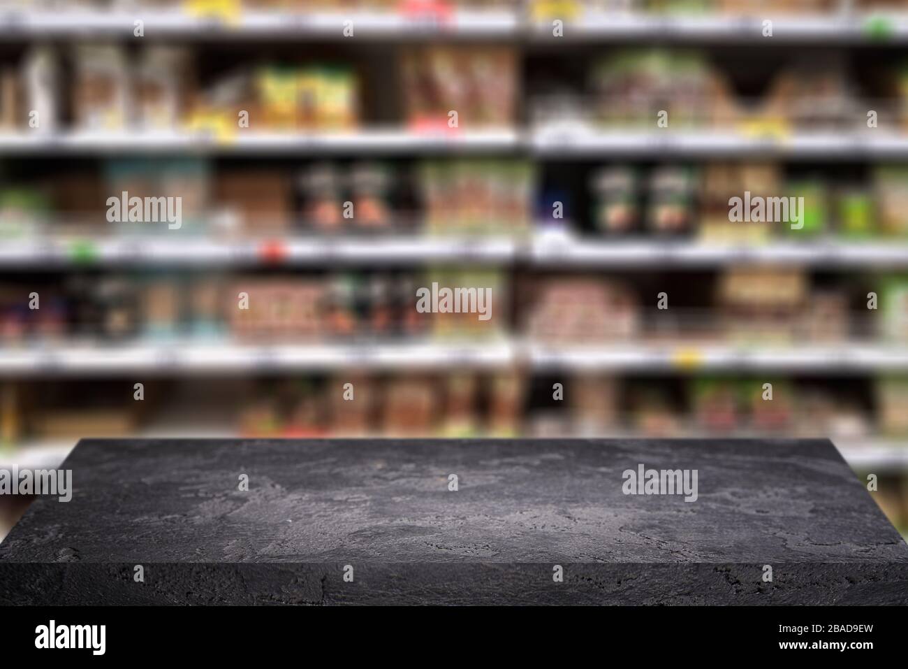 Black stone surface on blurry background at grocery store. Mock up for ...