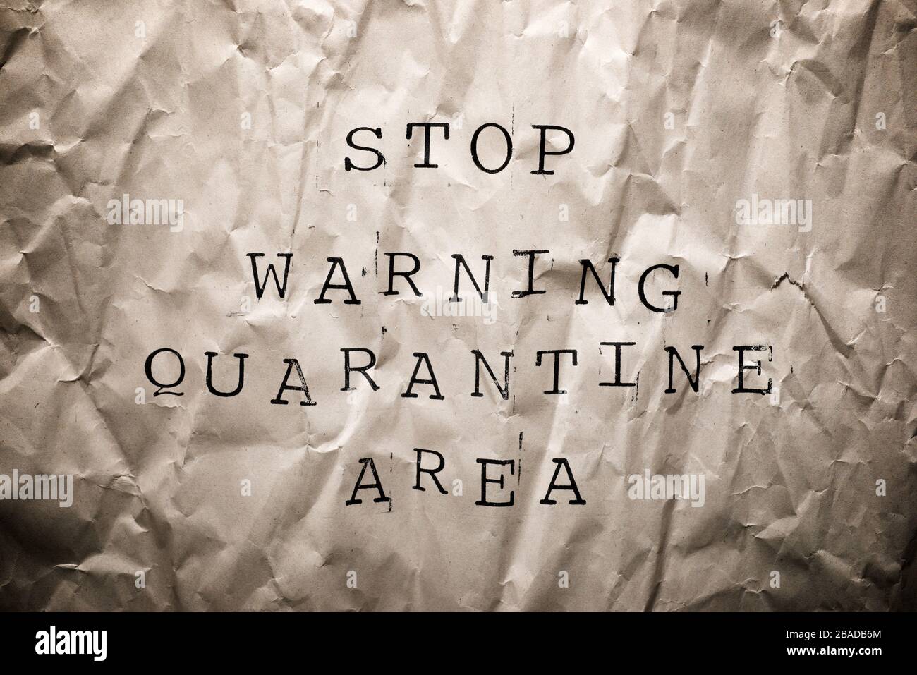 Stop Warning Quarantine Area text on a brown paper Stock Photo - Alamy