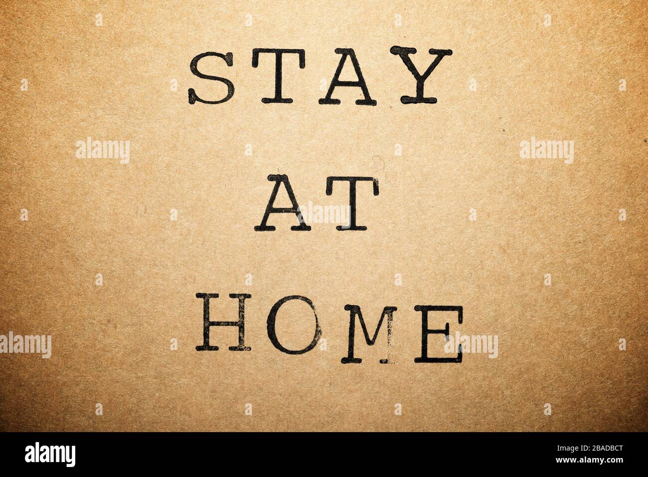 Stay at Home text on a brown paper Stock Photo - Alamy