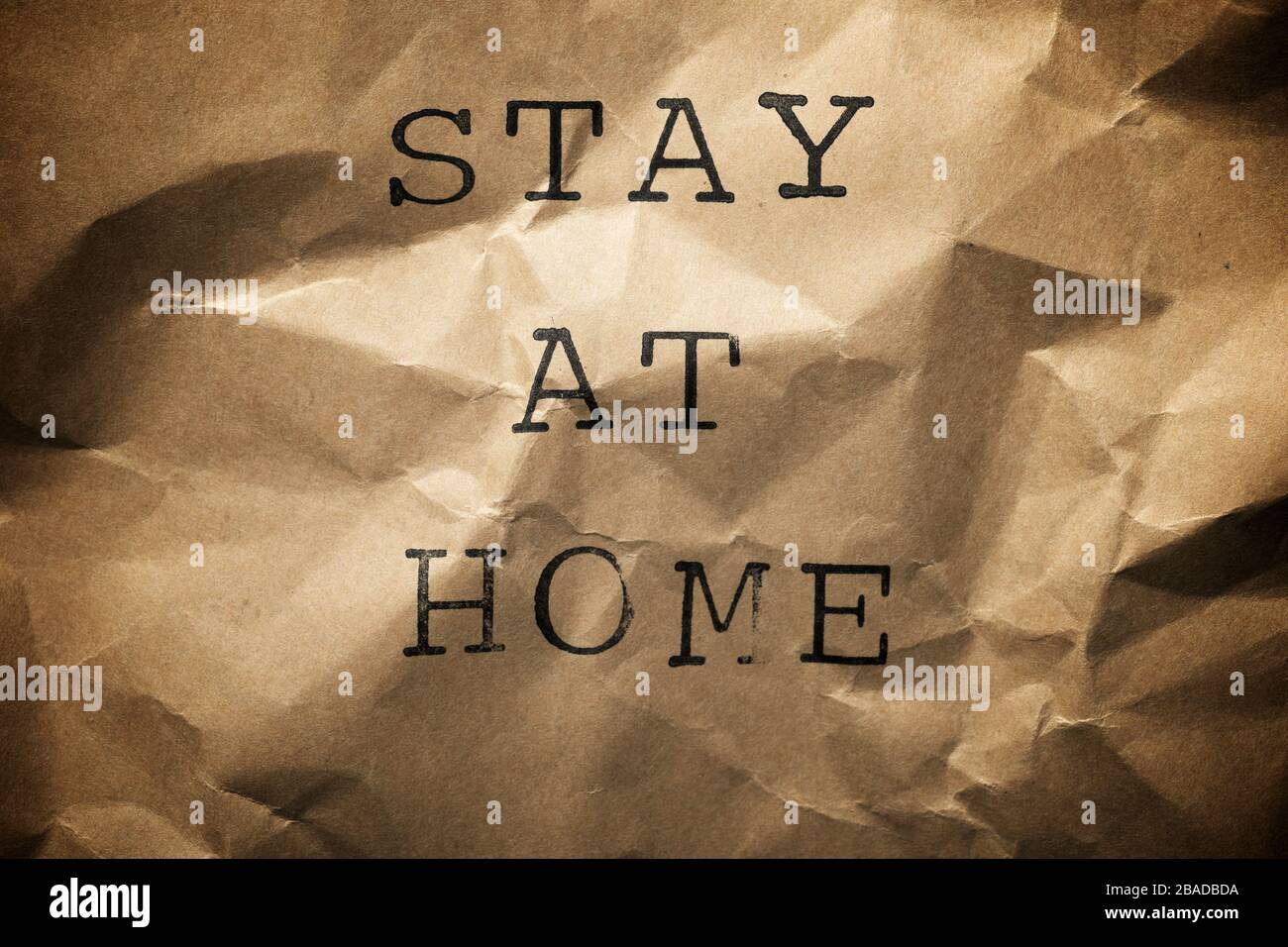 Stay at Home text on a brown paper Stock Photo - Alamy