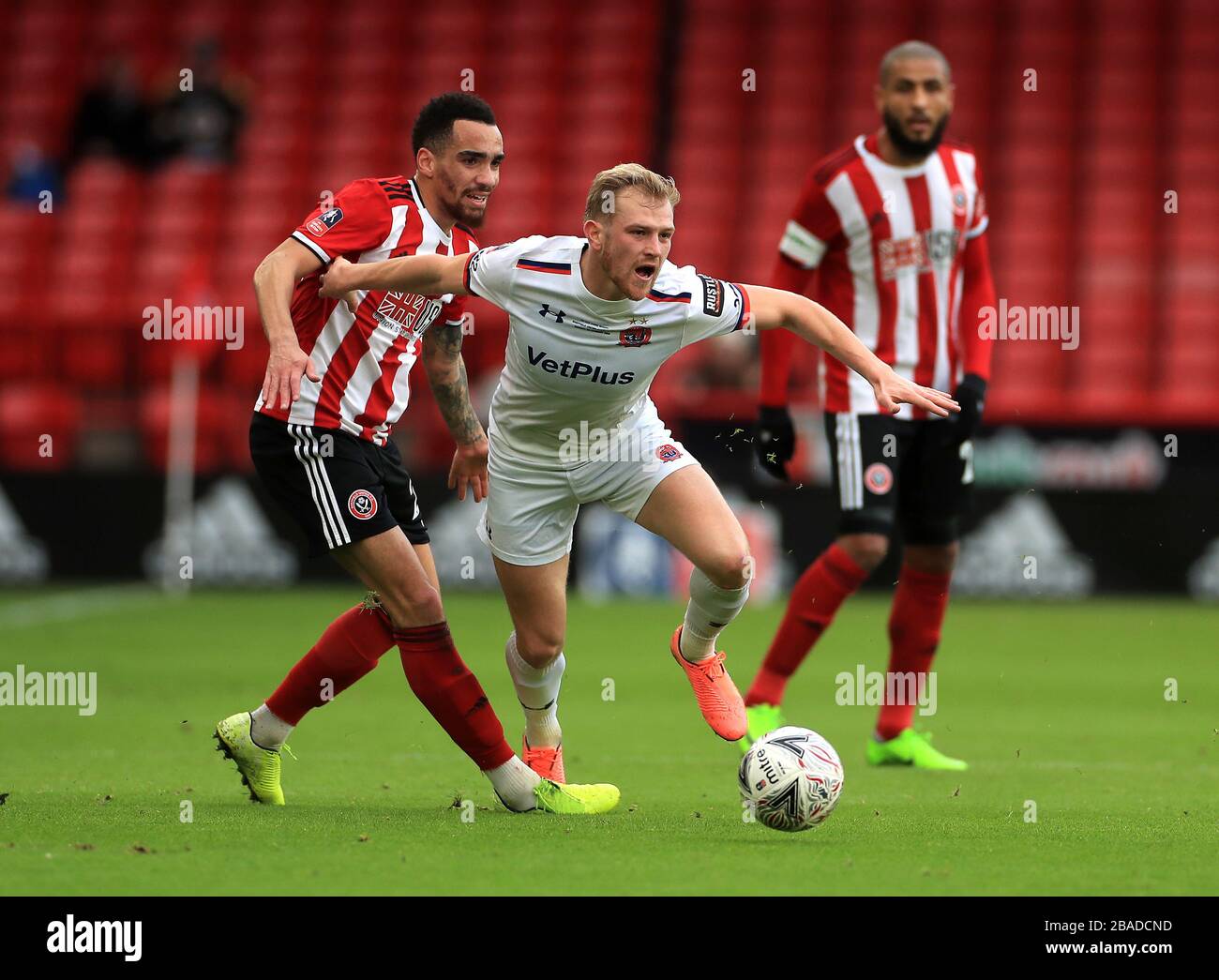 Sheffield United's Kean Bryan (left) and AFC Fylde's Ryan Crosadale ...