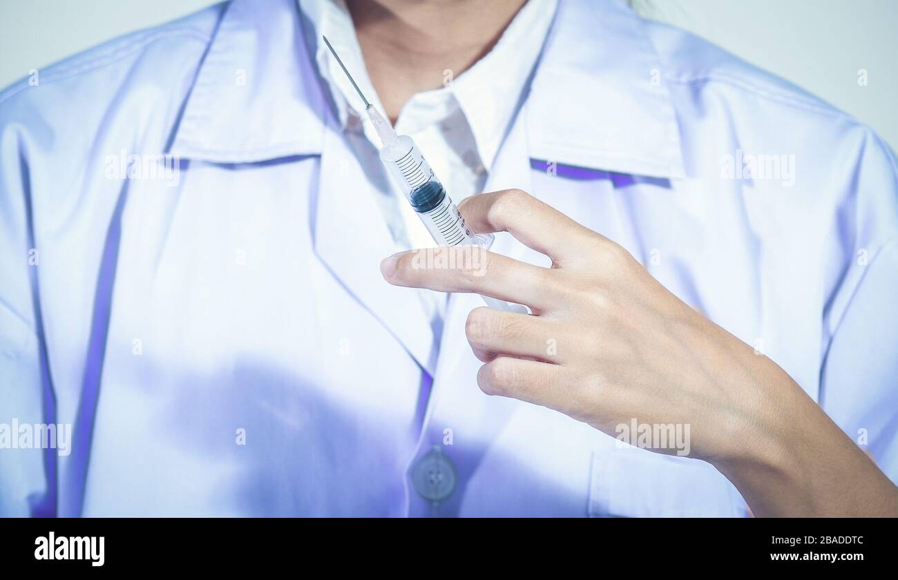 Doctor holding medical injection syringe and Medicine plastic ...