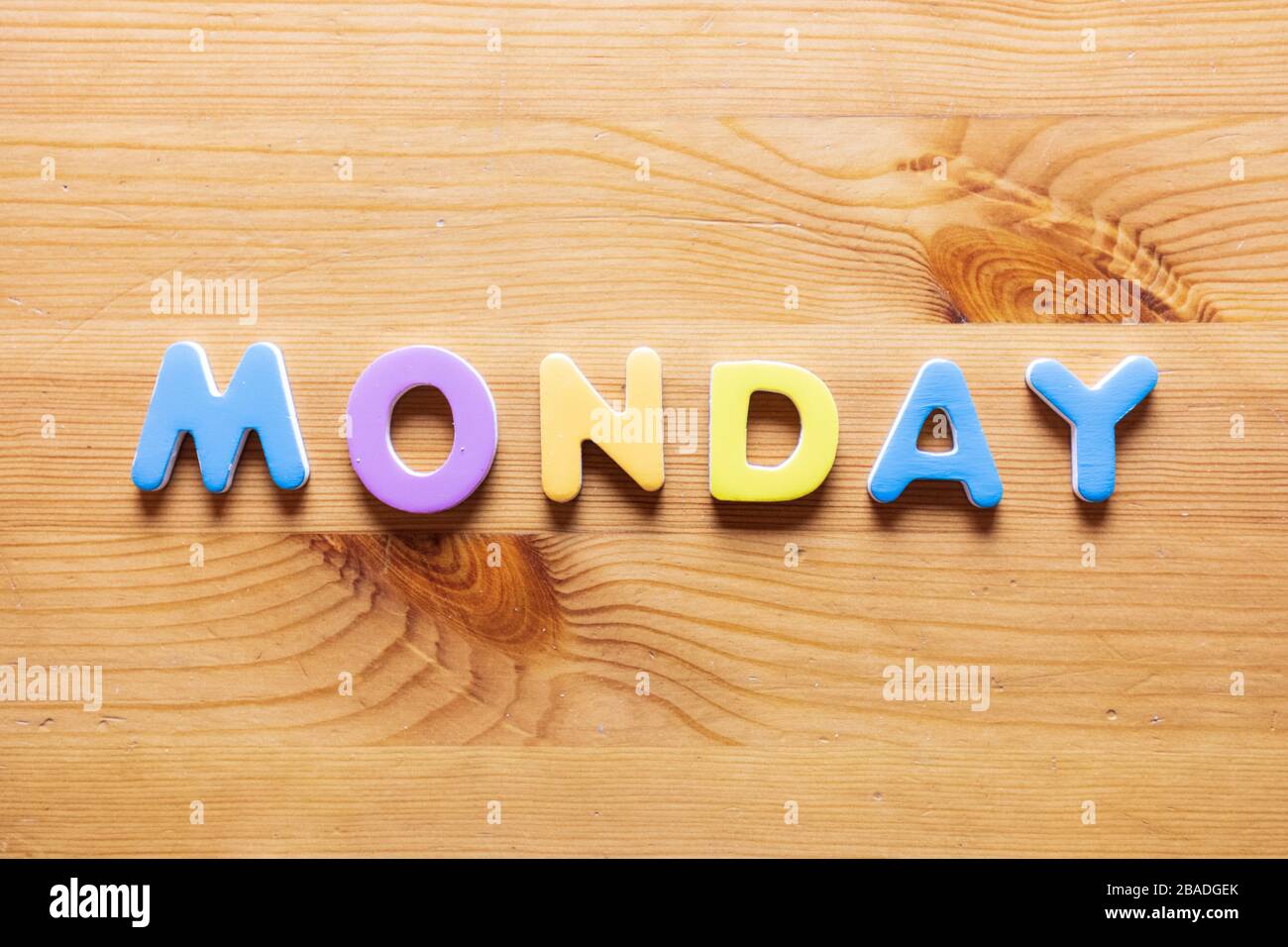 Monday word written with colorful letters on wooden table background ...