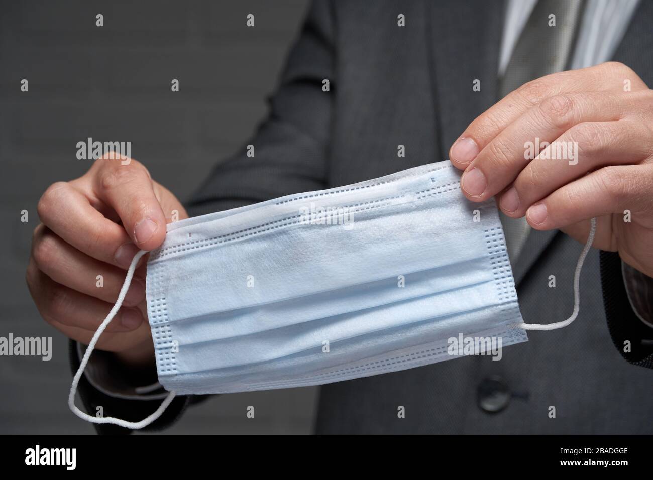 a man demonstrates a protective face mask for antivirus individual ...