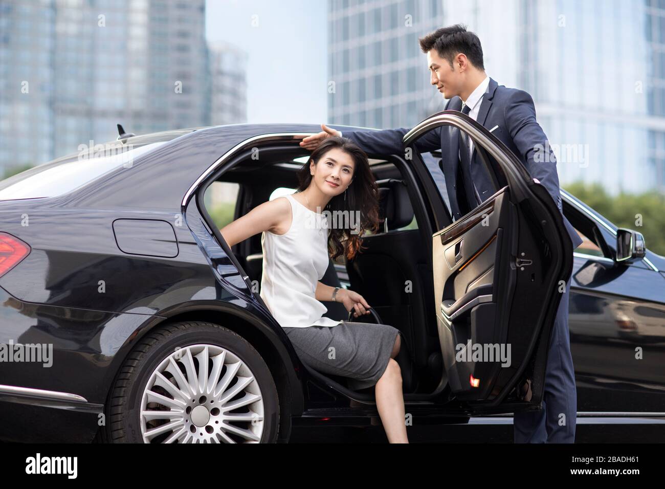 Confident Chinese businesswoman getting out of car Stock Photo - Alamy
