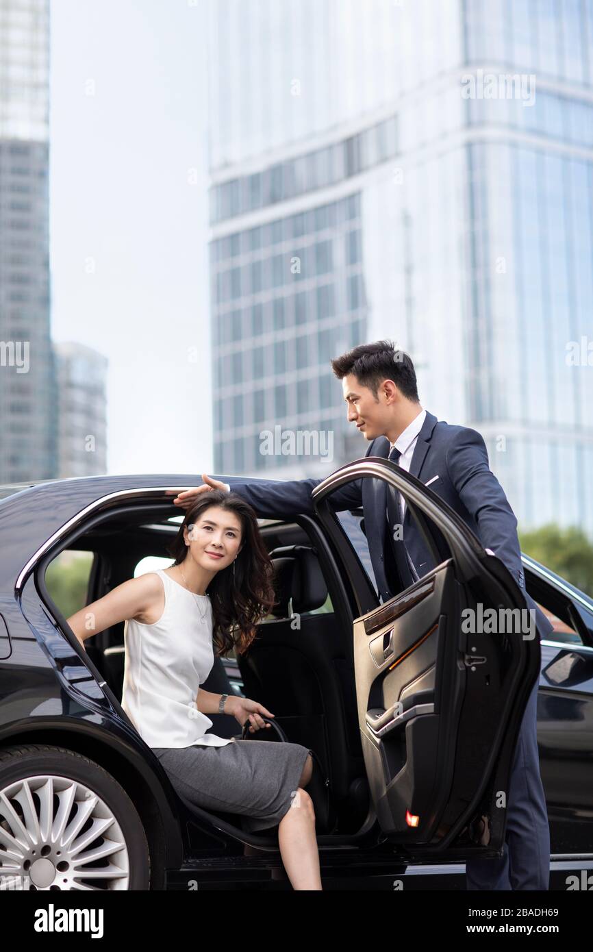 Confident Chinese businesswoman getting out of car Stock Photo - Alamy