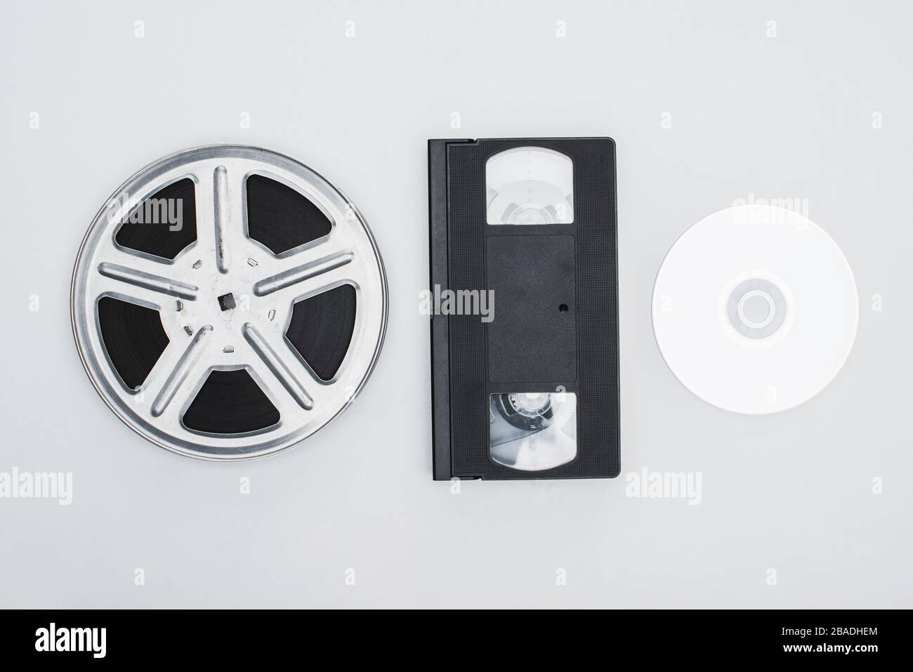 top view of film reel, VHS cassette and CD disc on white background ...