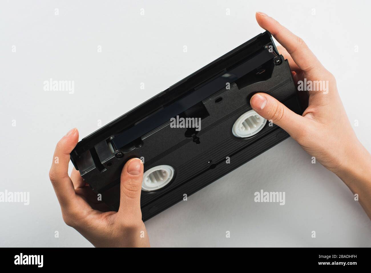 partial view of man holding old VHS cassette on white background Stock ...