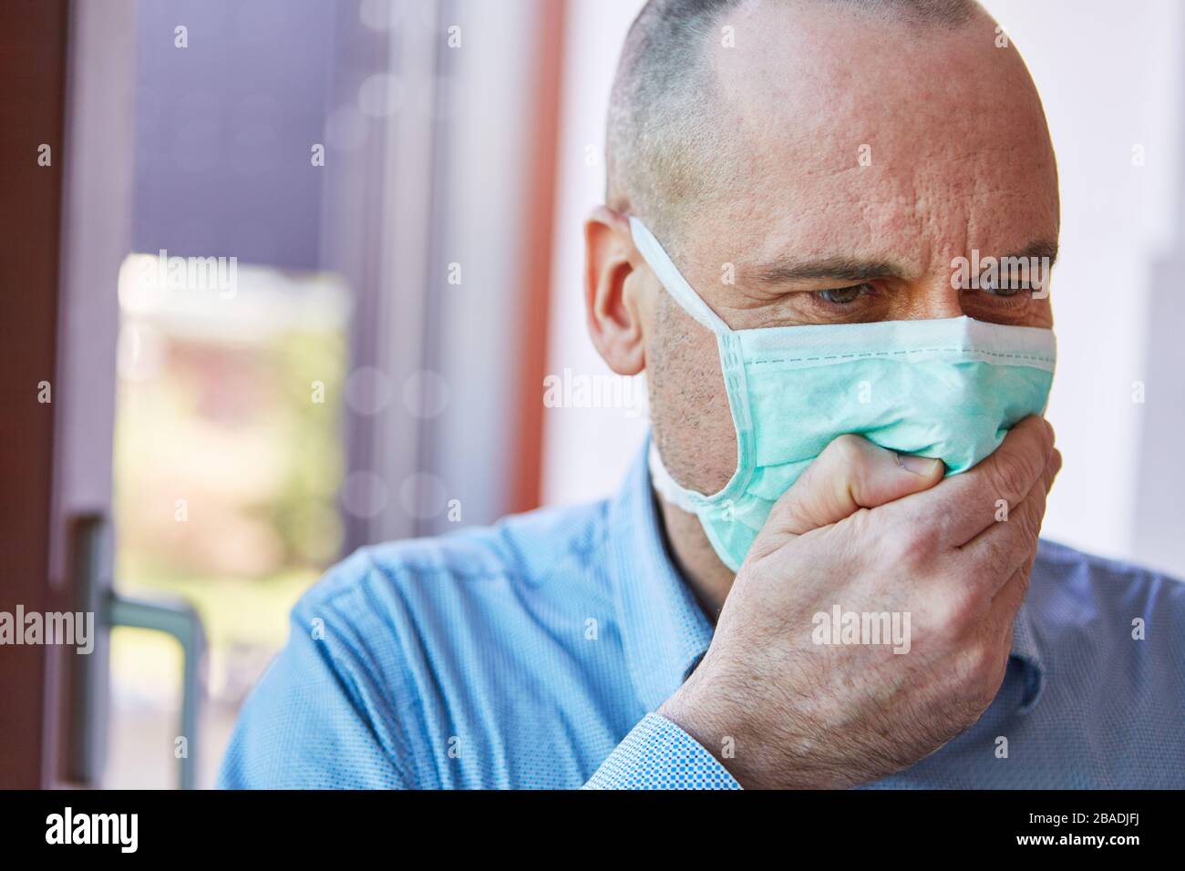 Covid-19 patient with mouthguard in quarantine at home when coughing in ...