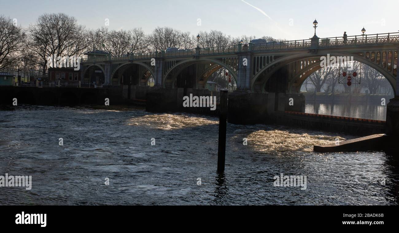 Sunlight coming through the arch of Richmond Lock with the barriers ...